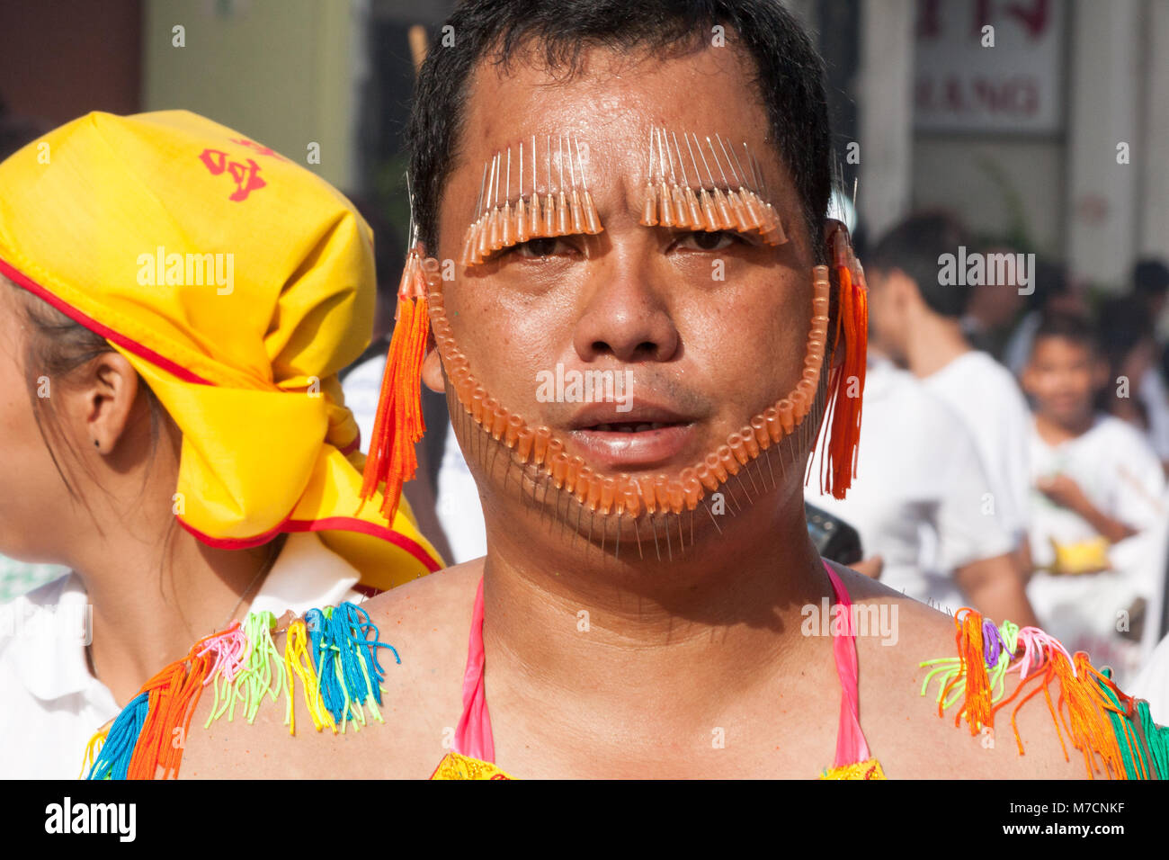 Man with face pierced by needles in a parade during the Nine Emperor ...