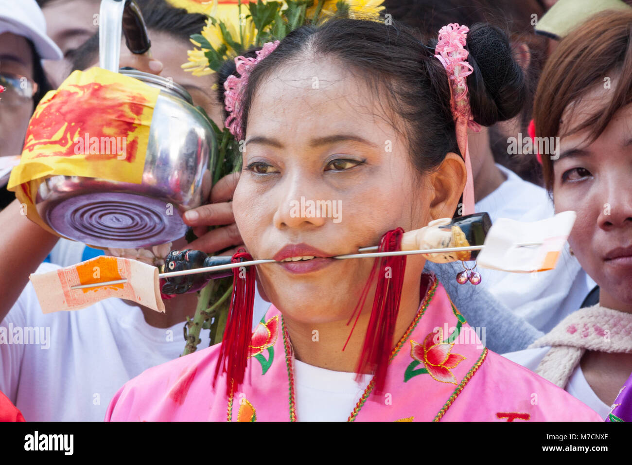 Woman with skewered cheeks in a parade during the Nine Emperor Gods ...