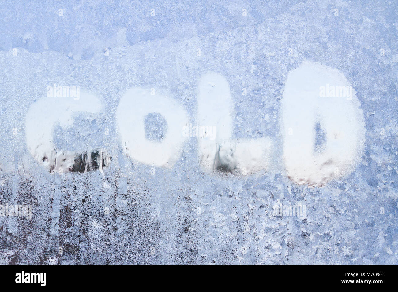The inscription is cold on a frozen window with patterns Stock Photo ...
