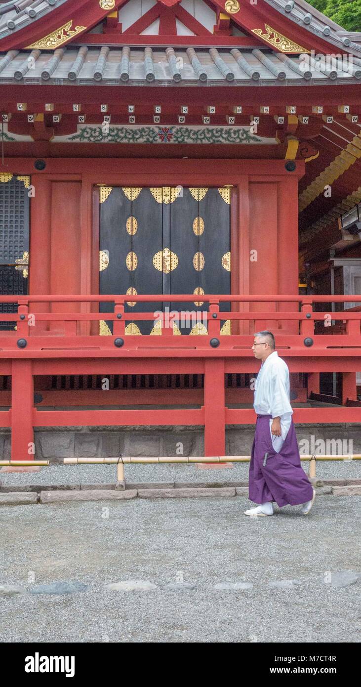 Colorfully dressed Japanese Shinto Priest walking in front of beautiful ...