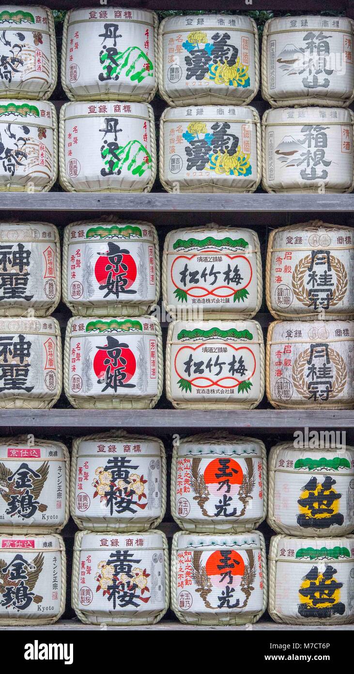 Very large display of rice sake barrels adorned with colorful labels in ...