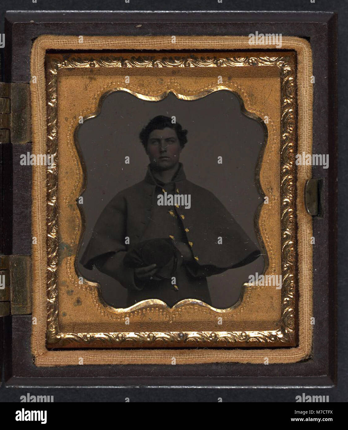 A photograph of an unidentified Union soldier wearing a greatcoat and ...