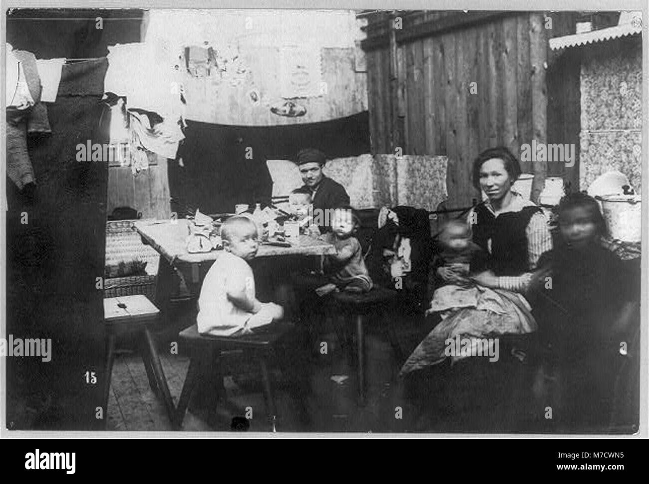 A historical photograph showing a family living in crowded conditions ...