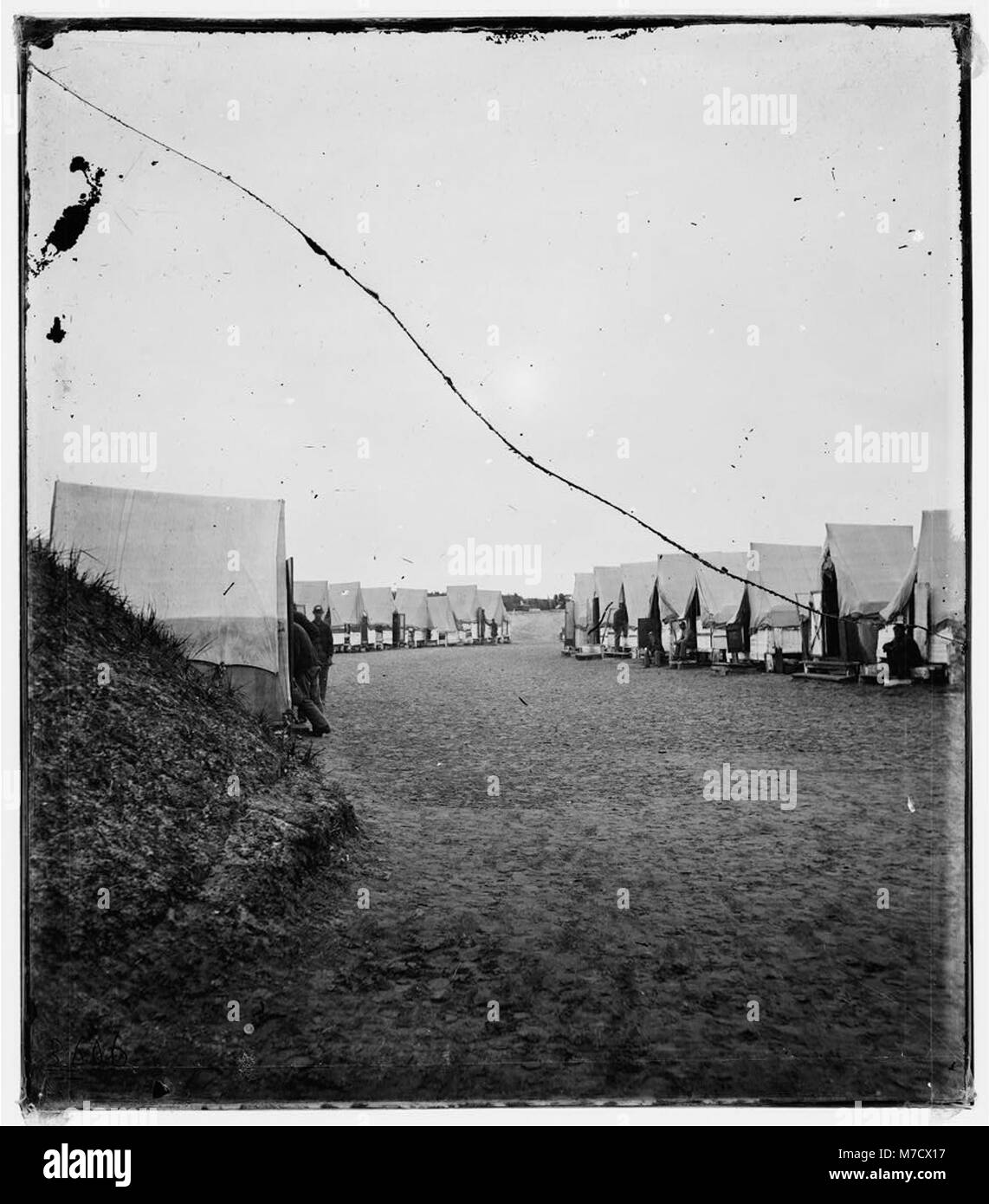 This image depicts a federal camp set up on a beach, likely during a ...