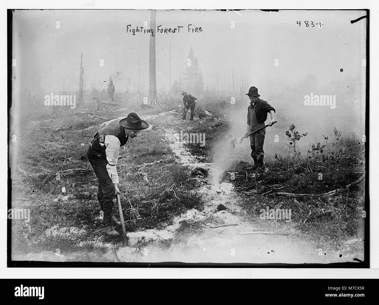 This image depicts firefighters combating a forest fire in South Dakota ...