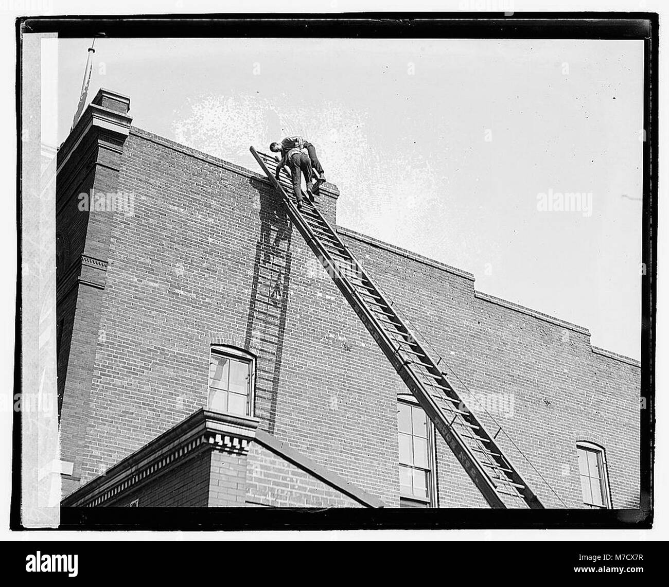 A scene at a firemen's school where recruits are trained in ...