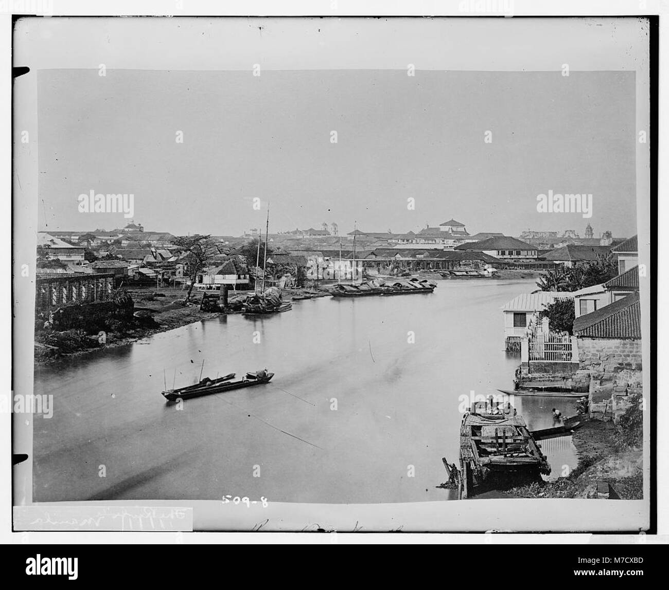 A photograph showing fishermen in Manila, capturing their traditional ...