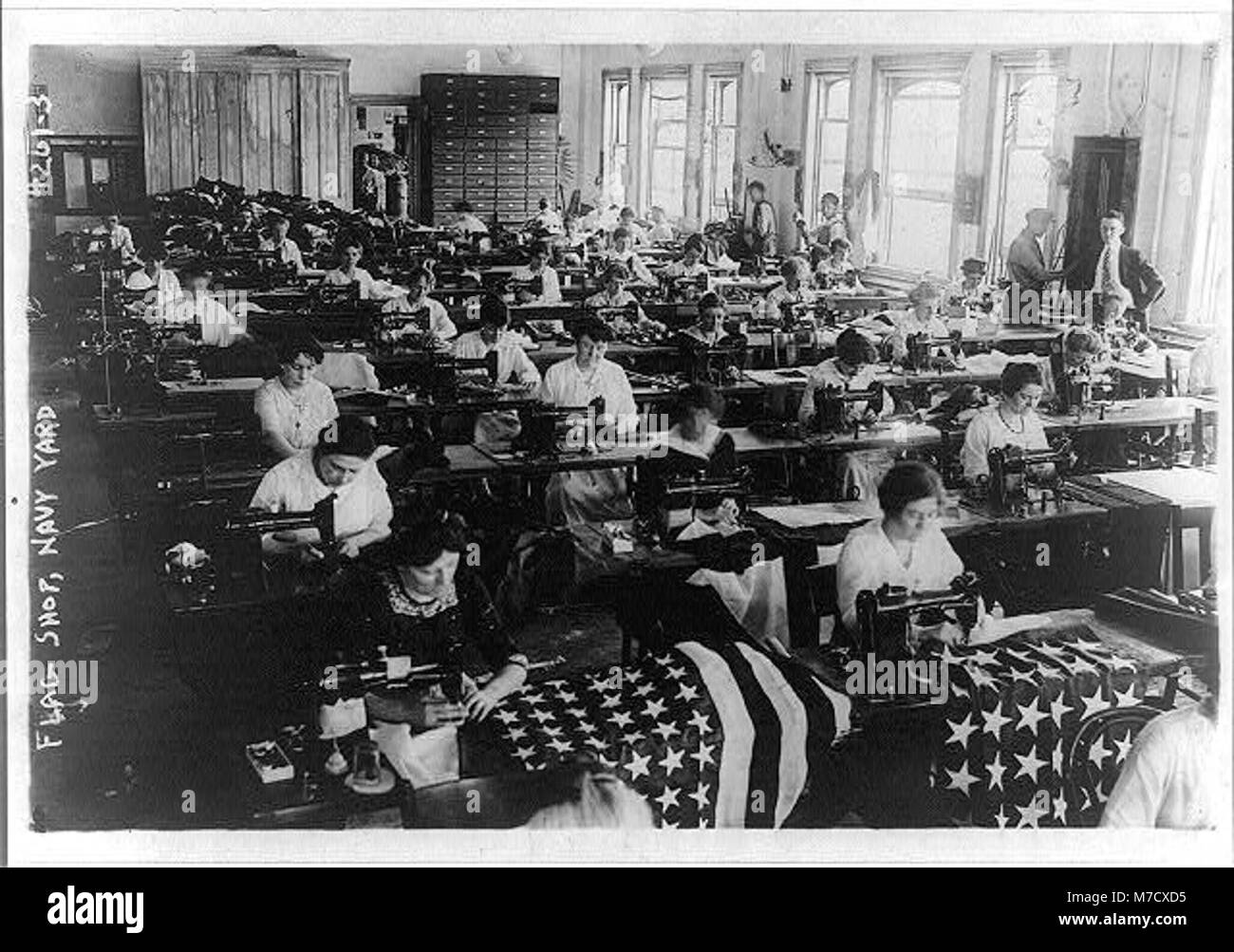 A photograph depicting a flag shop located at the Navy Yard. The image ...