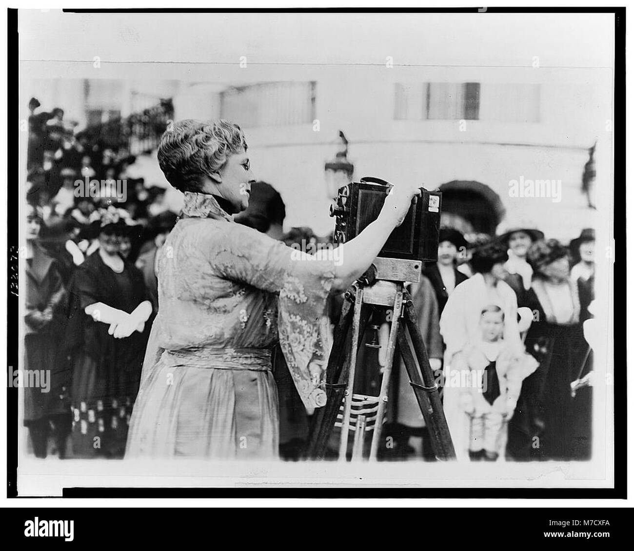 A photograph of Florence Kling Harding operating a movie camera on the ...