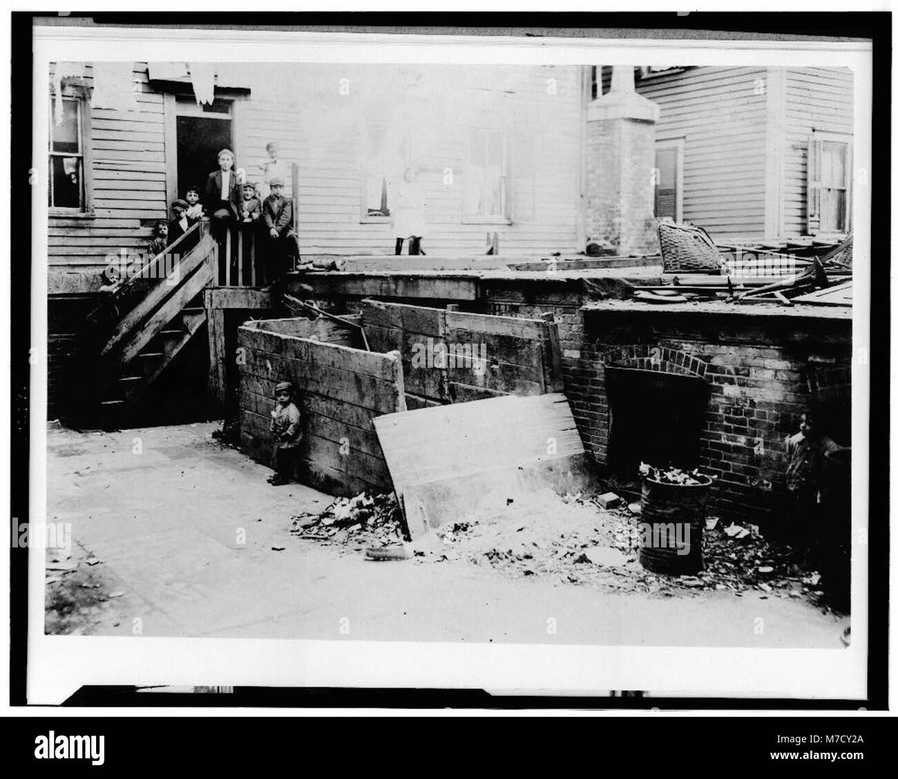 This photograph shows the entrance of a crowded and unsanitary house ...