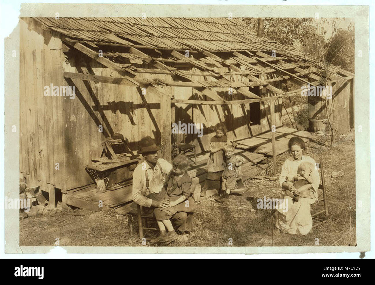 A photograph of Frank Burditt and his family, living in a dilapidated ...