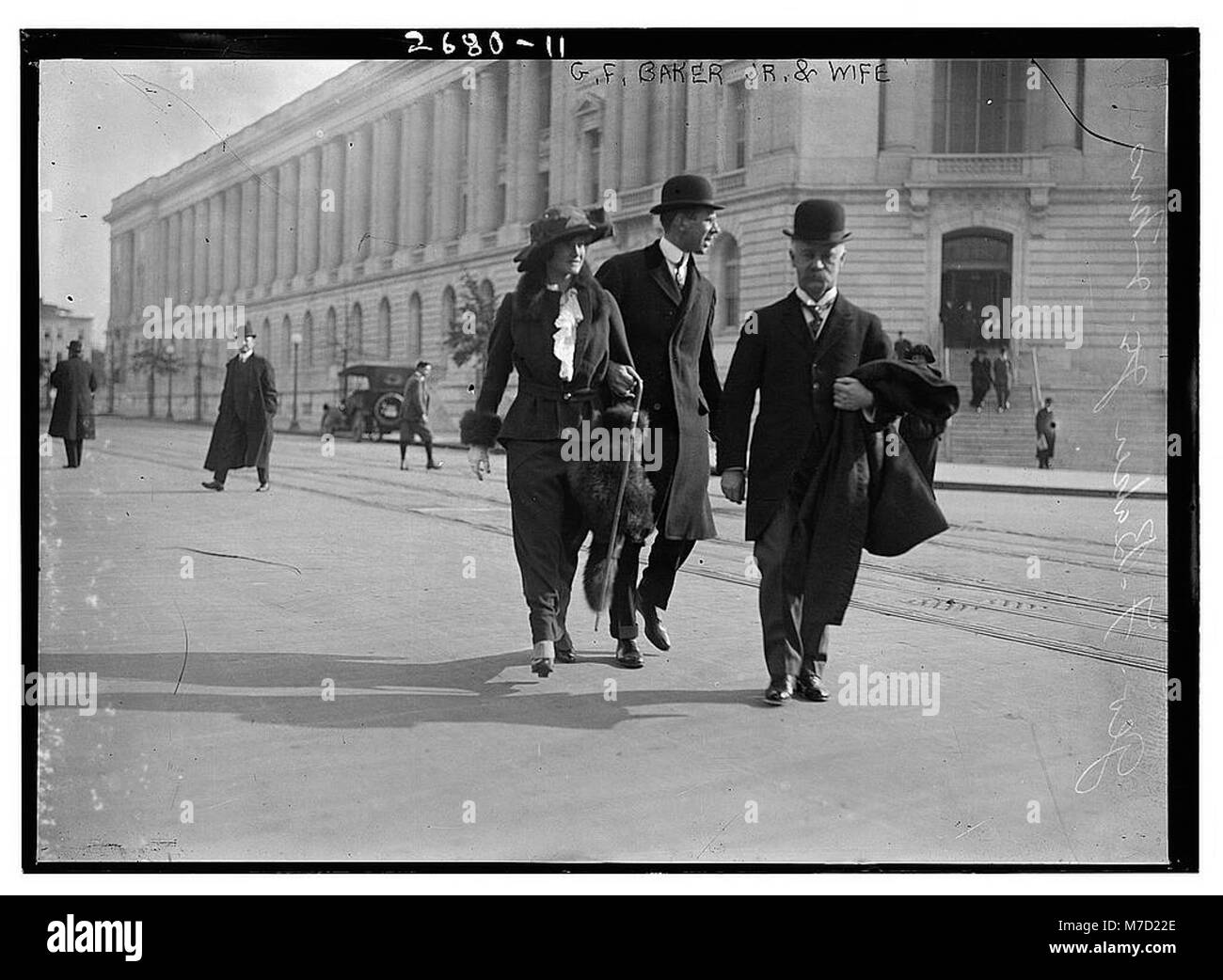 A formal portrait of Geo. F. Baker Jr. and his wife, captured in a ...