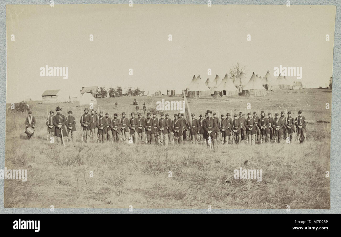 Union soldiers lined up in the field with tents in the background ...