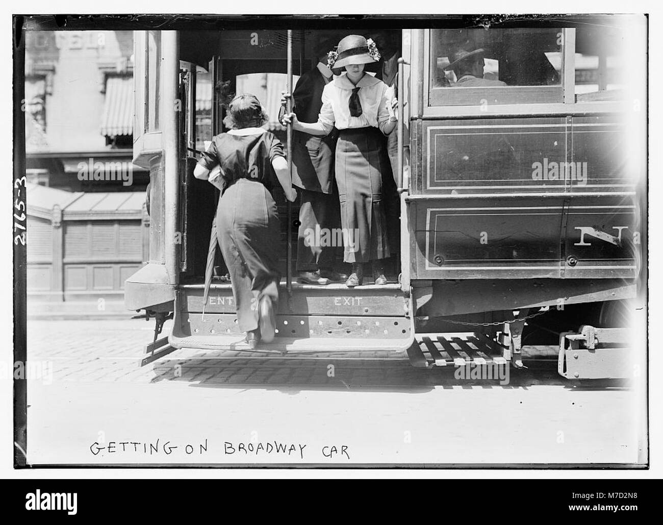 This image shows a person boarding a Broadway car, a type of streetcar ...