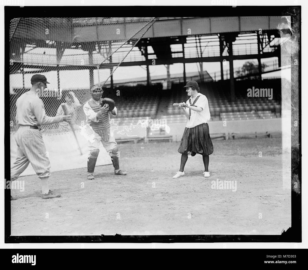 A photograph of young girls playing baseball, showcasing the growing ...