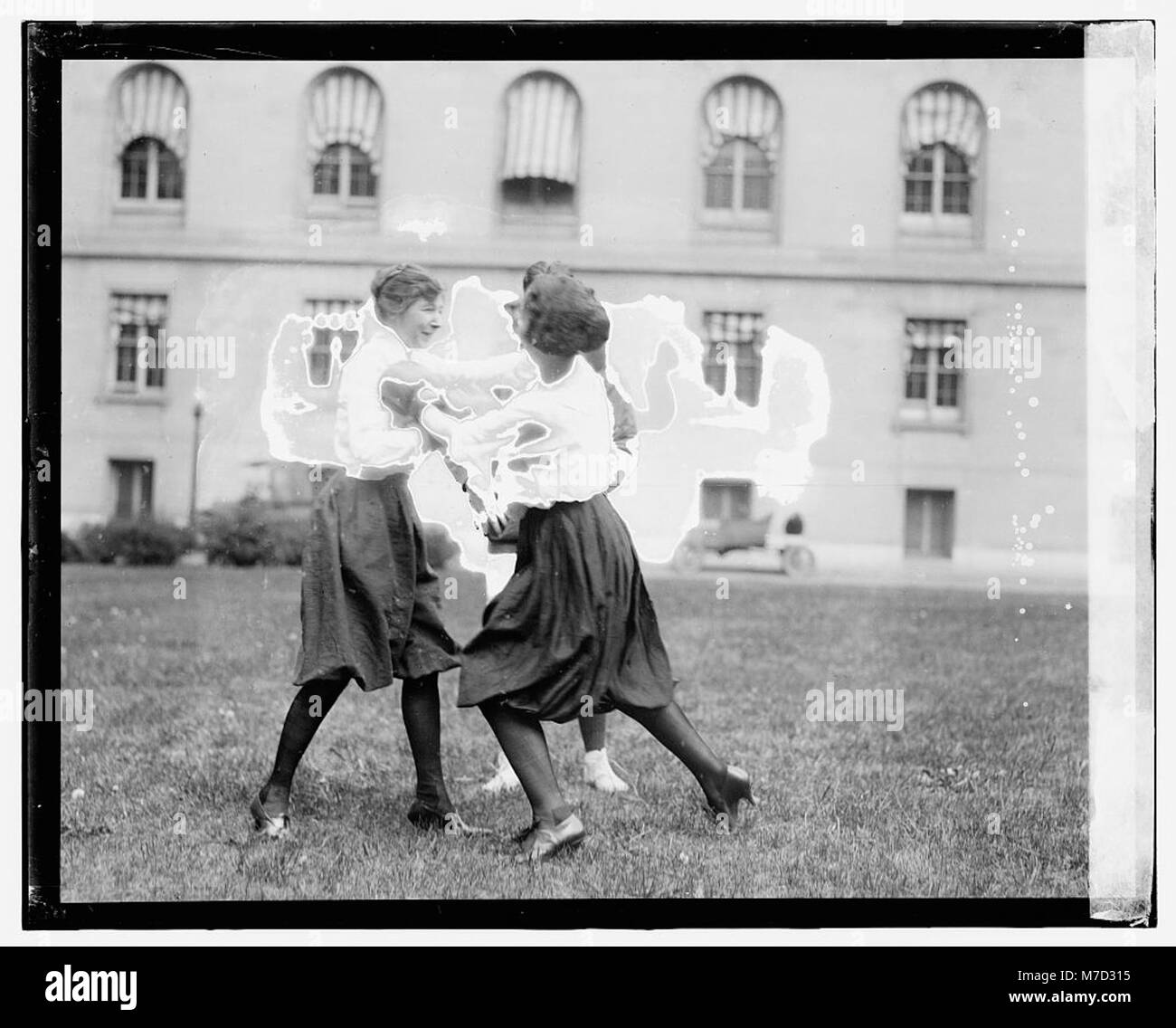 A photograph showing a group of girls in a house setting, reflecting a ...