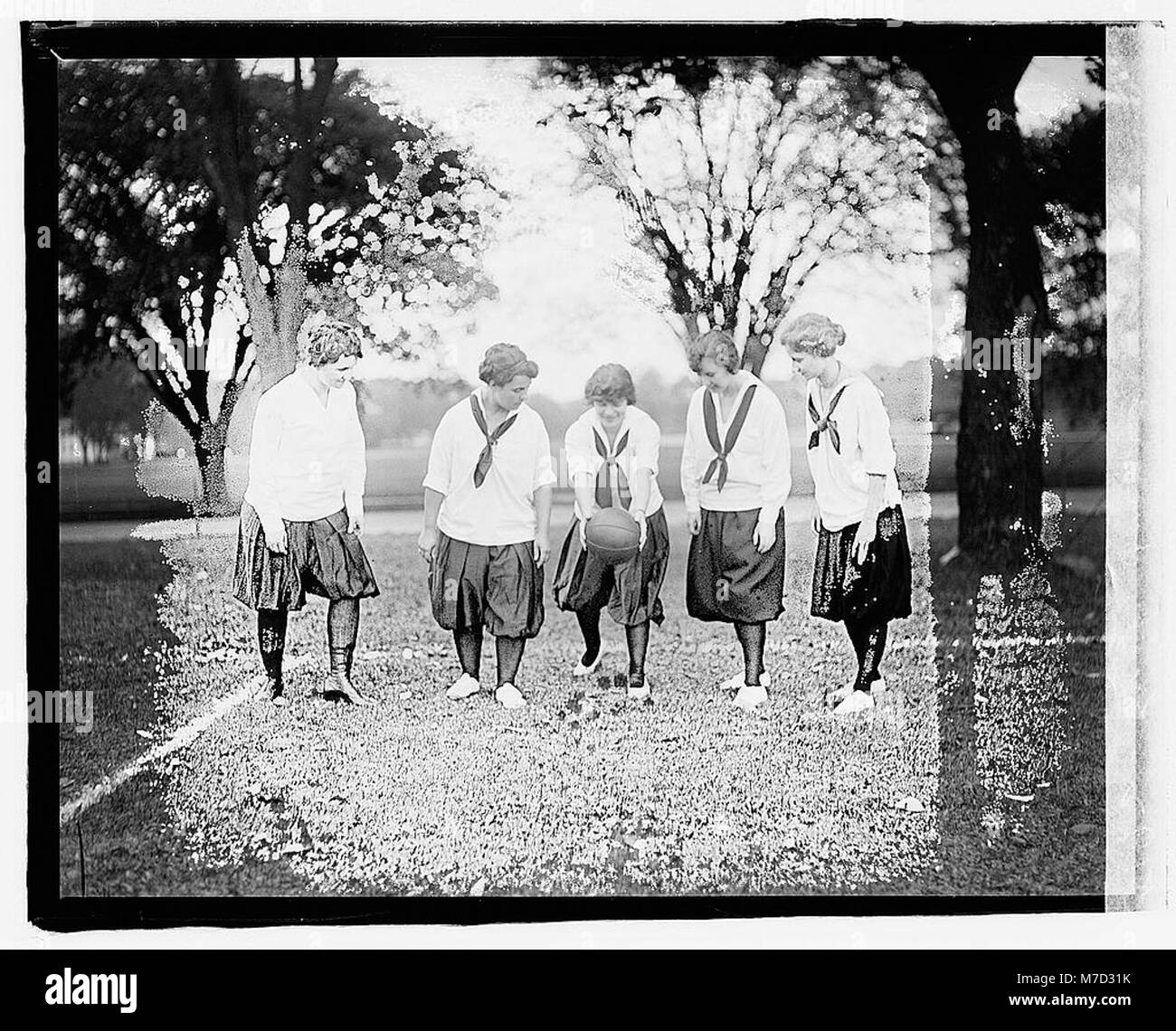 This image shows a girls' soccer team in action, capturing the dynamic ...