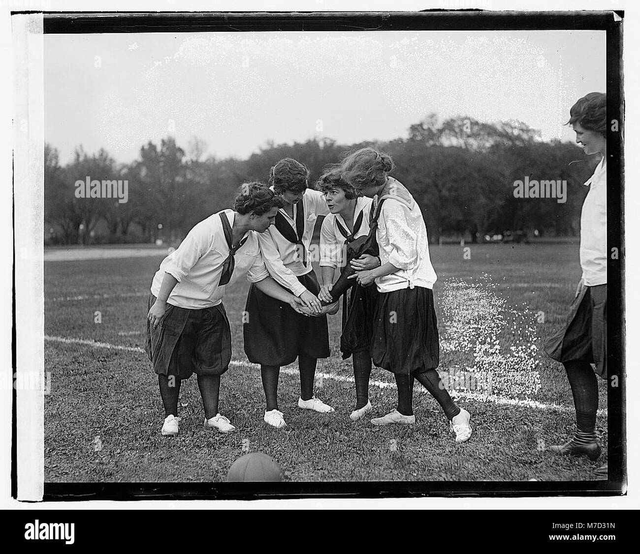 A girls' soccer team is shown in action, emphasizing teamwork ...