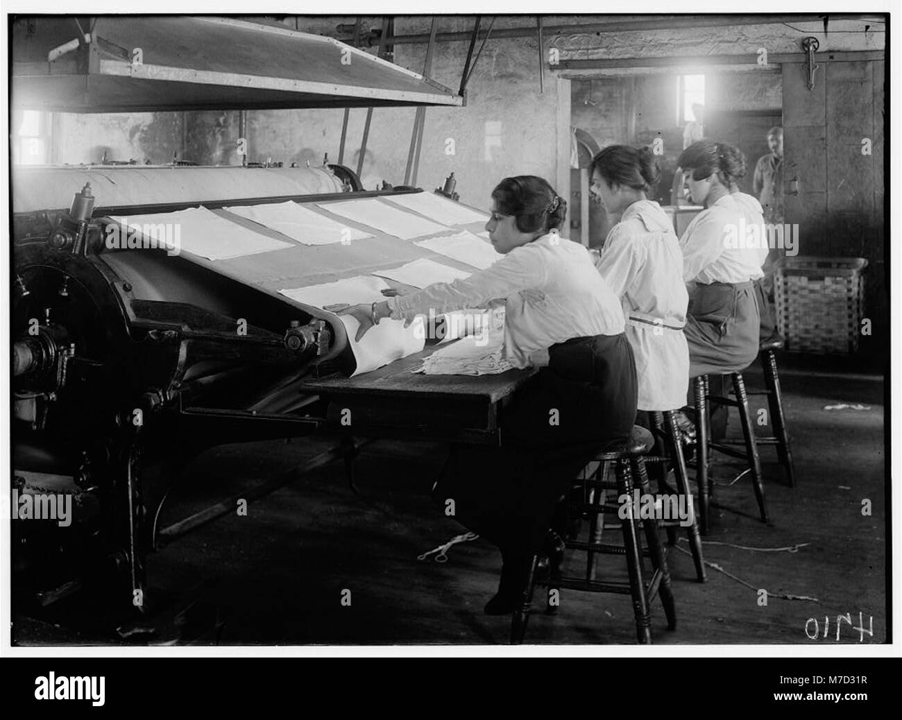 A photograph depicting young girls working at a mangle in the Bonanno ...