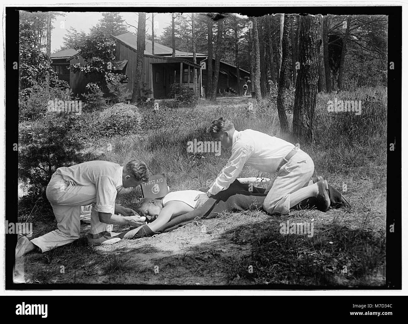 The image shows the act of administering first aid, emphasizing the ...