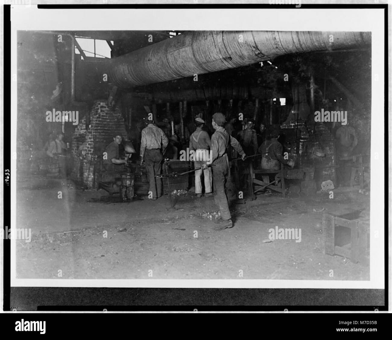 This image depicts the workers at a glass works factory during the day ...