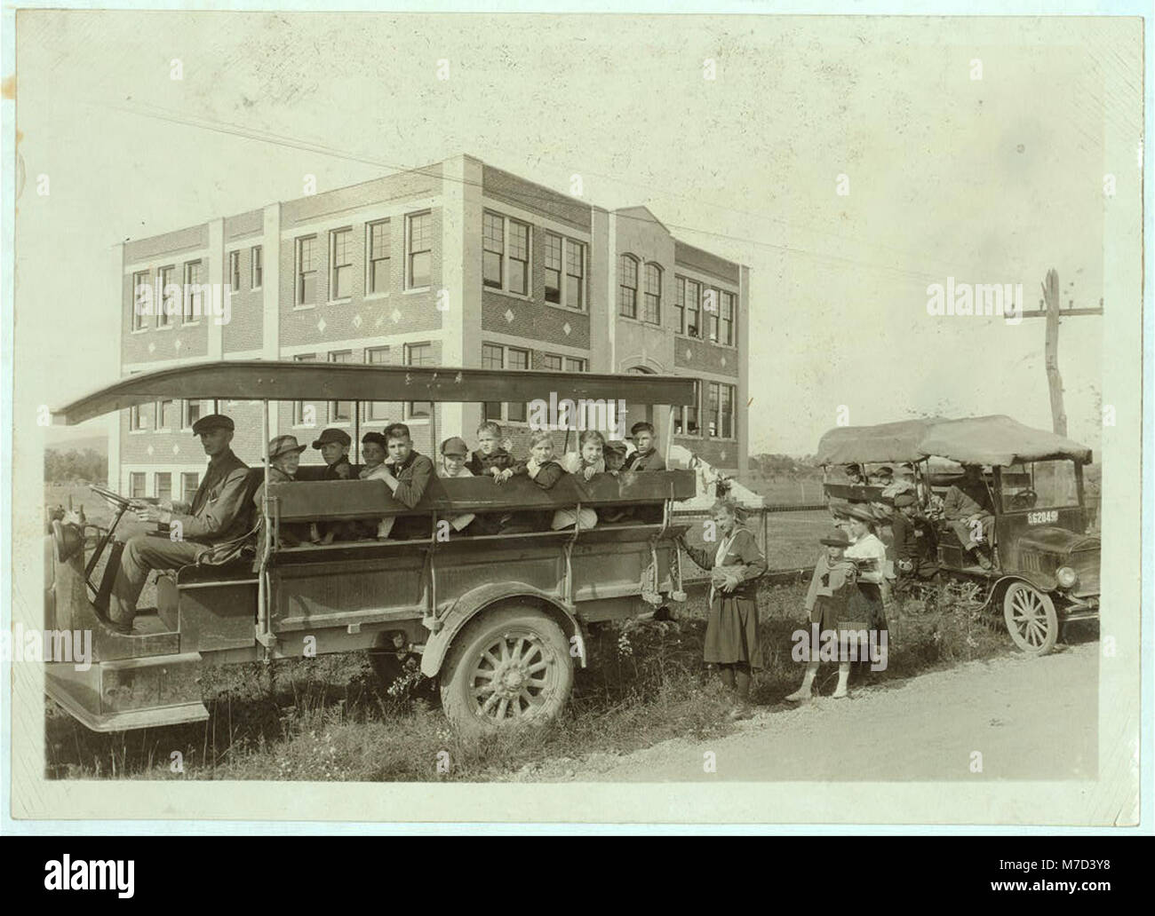 A photograph showing students loading onto buses for the six-mile trip ...