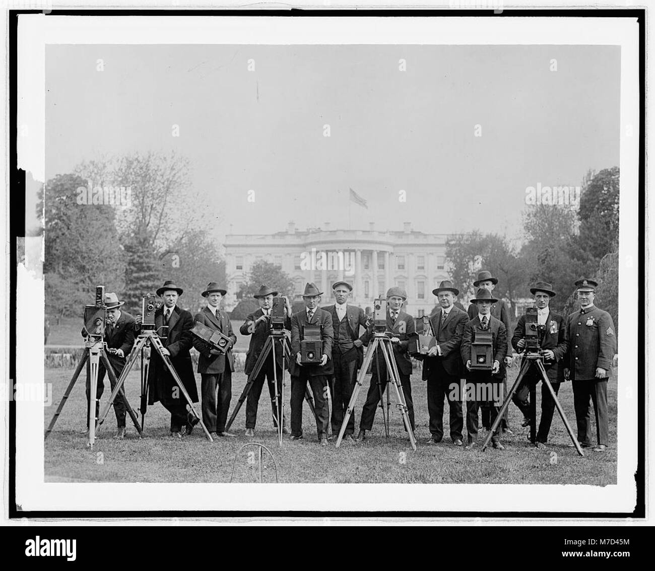 A group of cameramen captured in a photograph, likely documenting ...