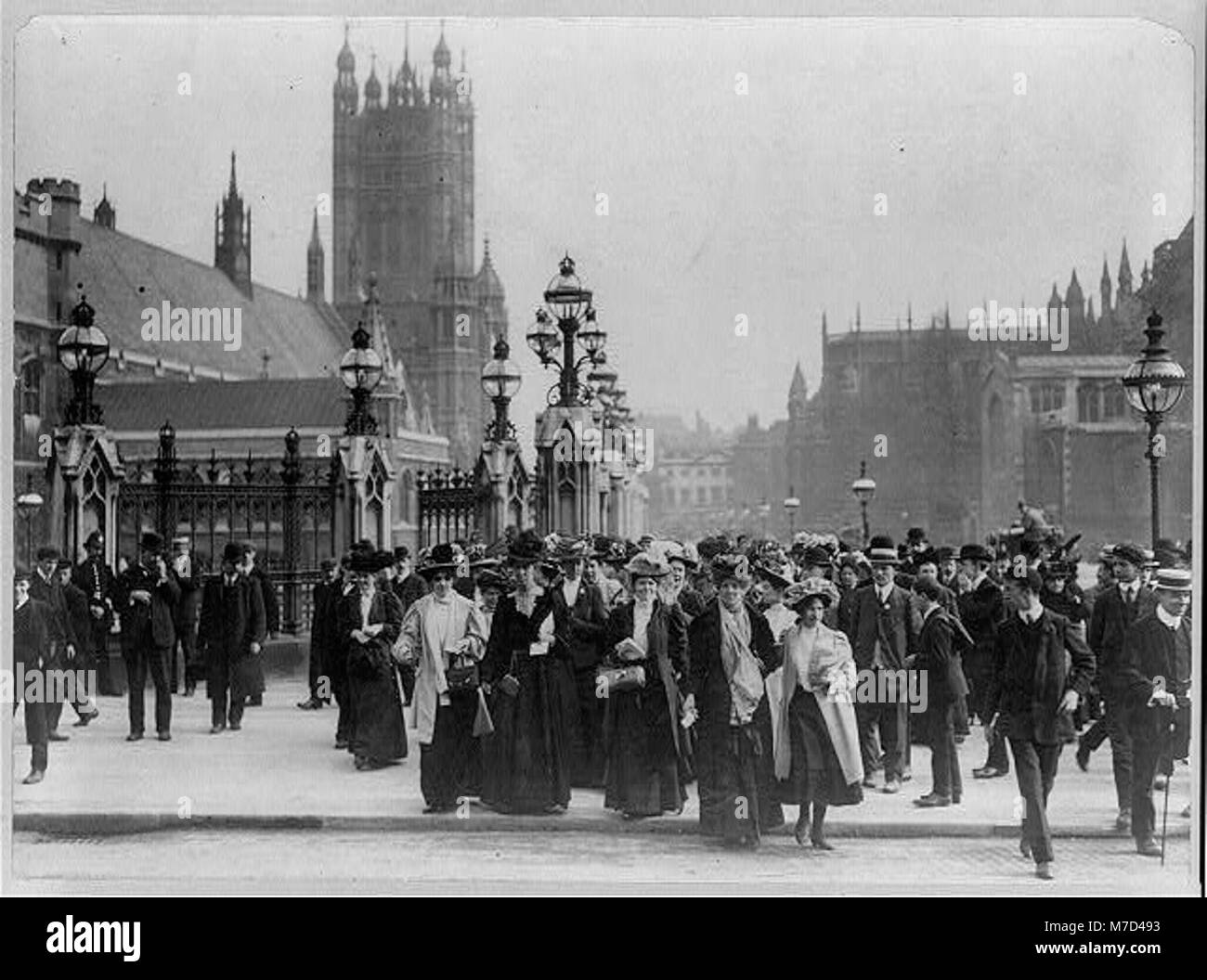 A group of suffragettes stands outside the British Parliament around ...