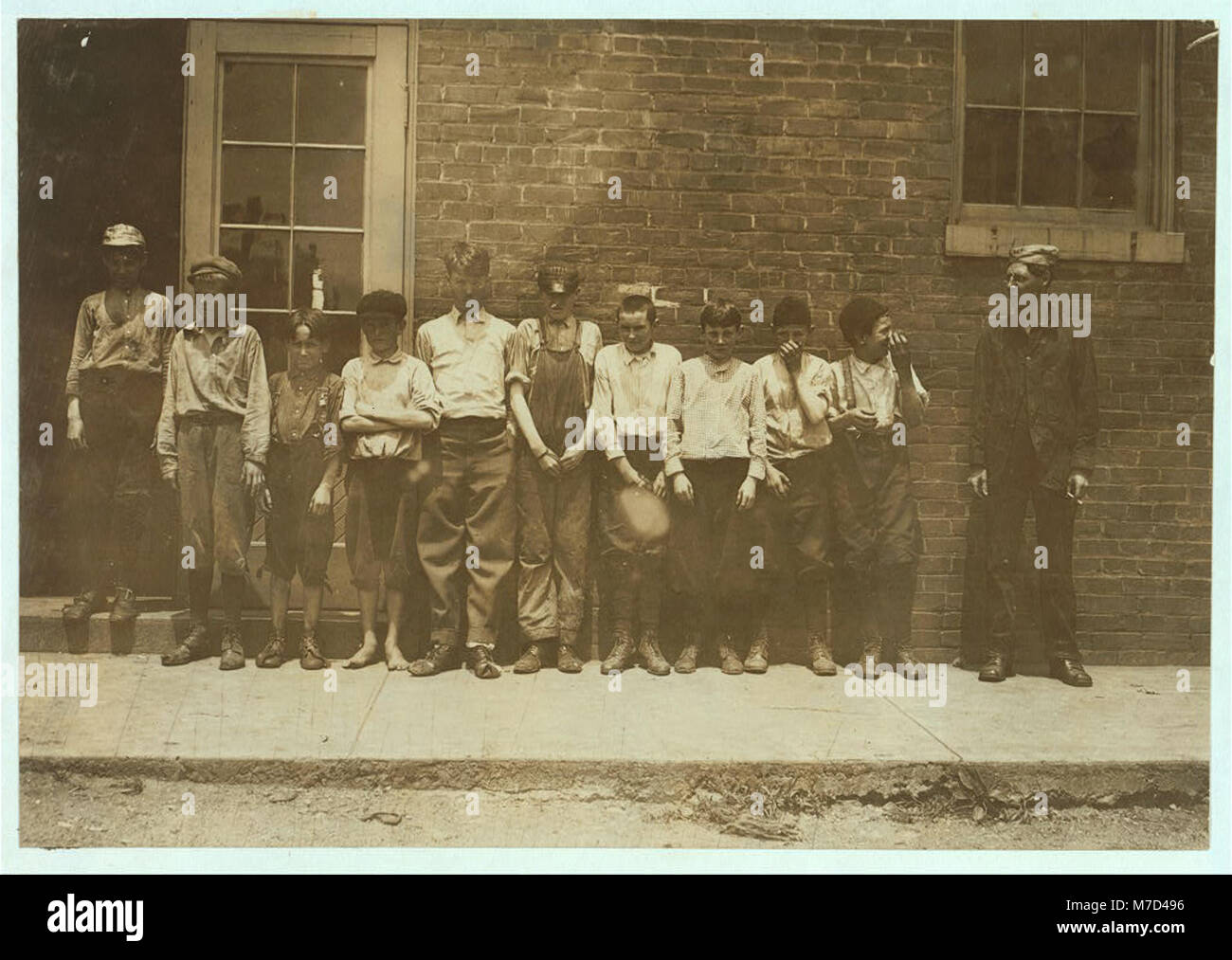 A group of young boys work as tack-pullers in the West End Shoe Factory ...