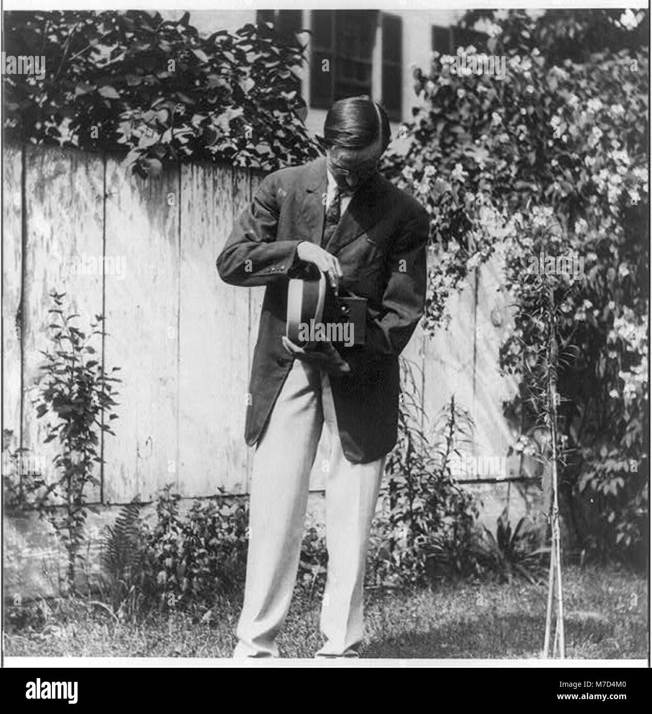 An image of H.E. French using a box camera. The photograph emphasizes ...
