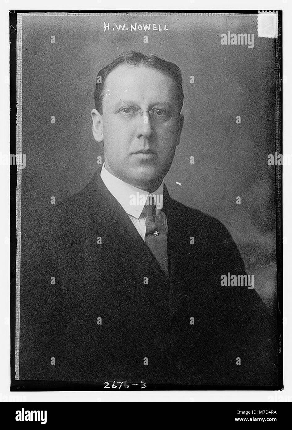 A formal portrait of H.W. Nowell, captured in a studio setting. The ...