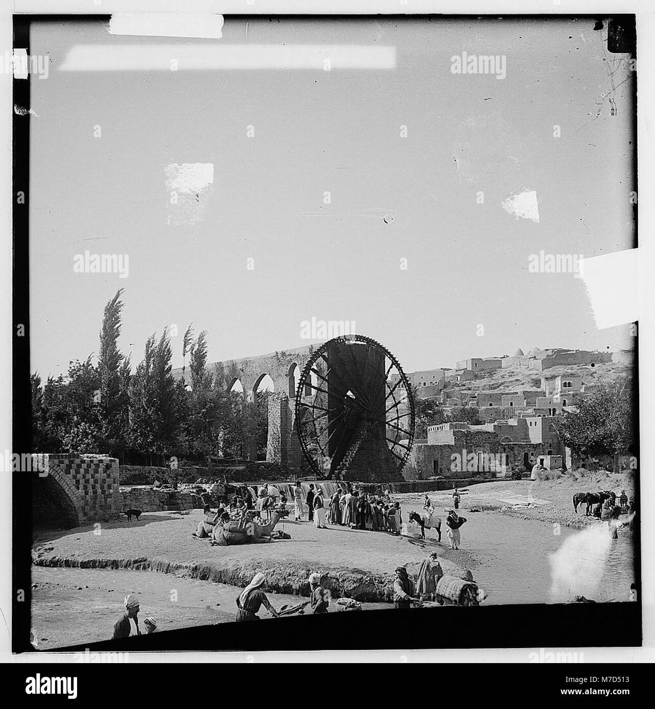 A bustling scene in Hama, Syria, along the Orontes River, showing daily ...