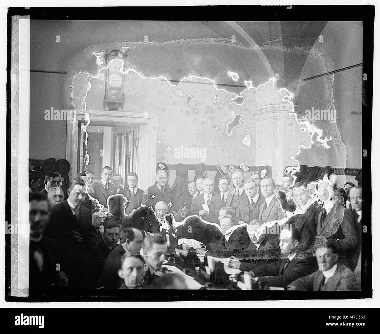 A historical photograph of President Warren G. Harding surrounded by ...