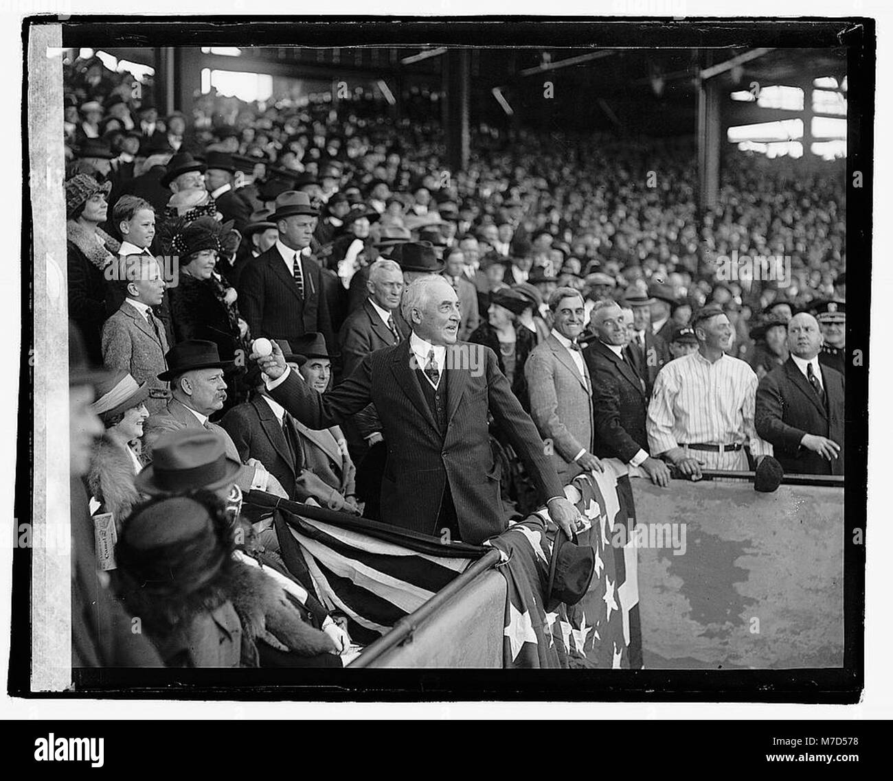 A historical photograph of President Warren G. Harding throwing the ...