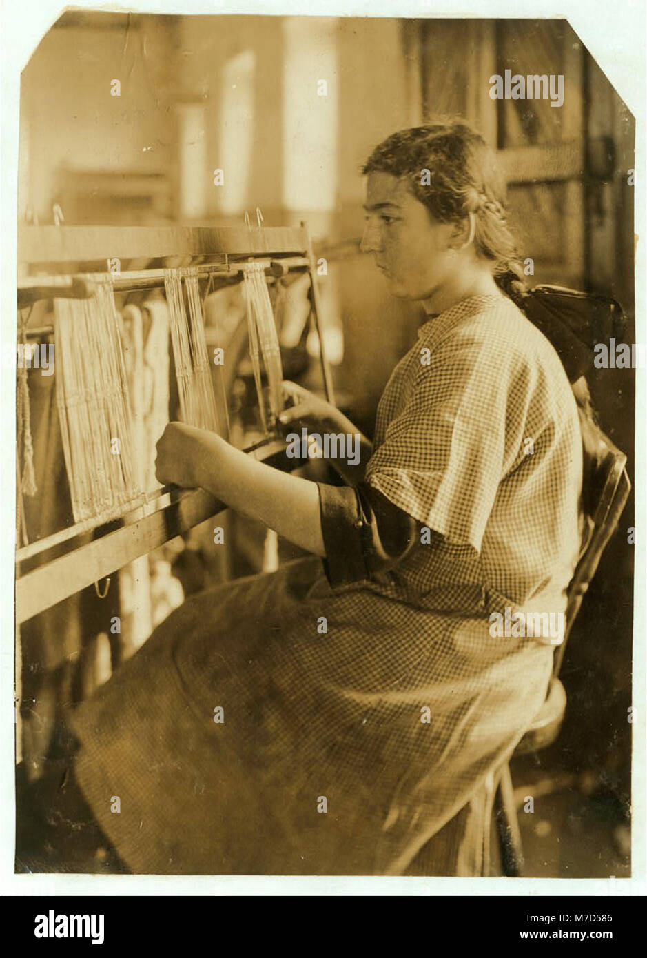 A harness maker is shown in the process of creating horse-drawn vehicle ...