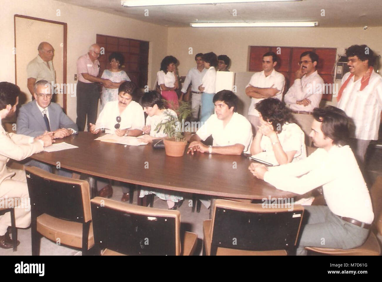 A reunion of workers is captured in this photograph, highlighting the ...