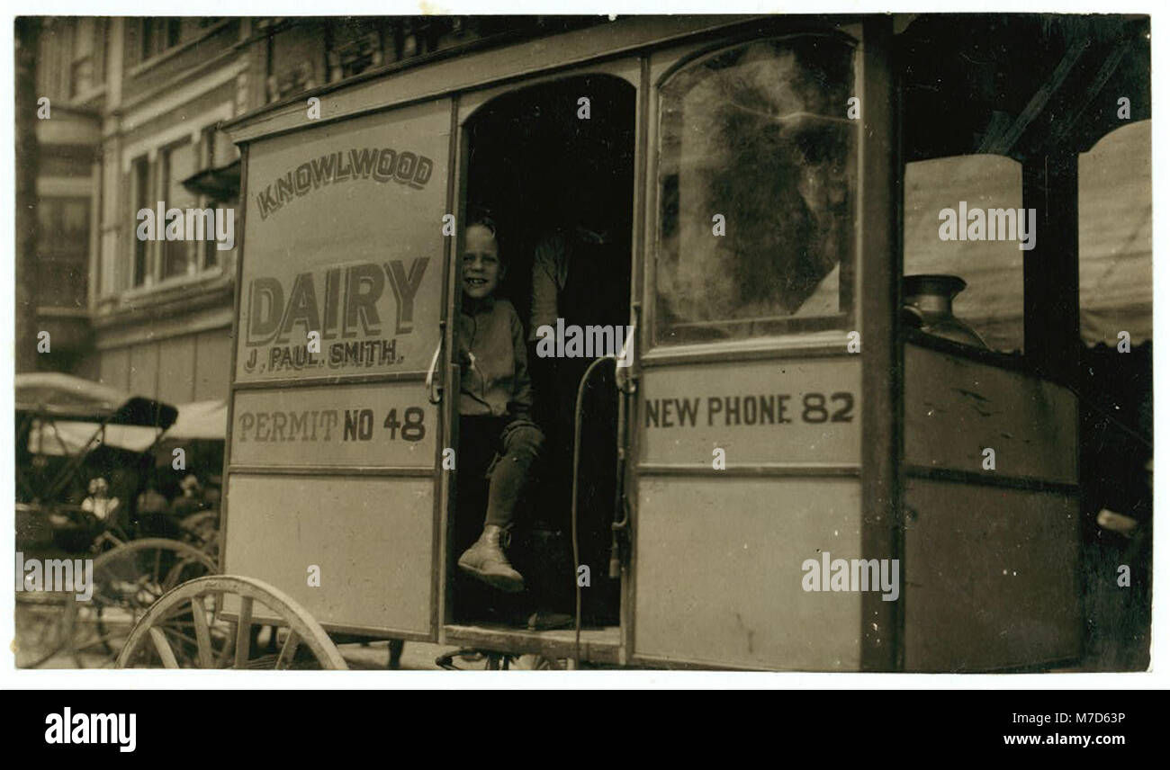 A photograph of a helper working on a dairy wagon, reflecting the daily ...