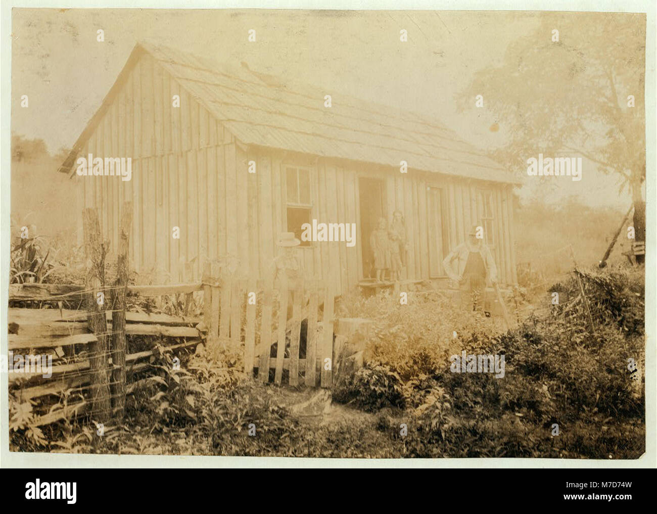 The photograph depicts the home of Dewey Coffey and his family. The ...
