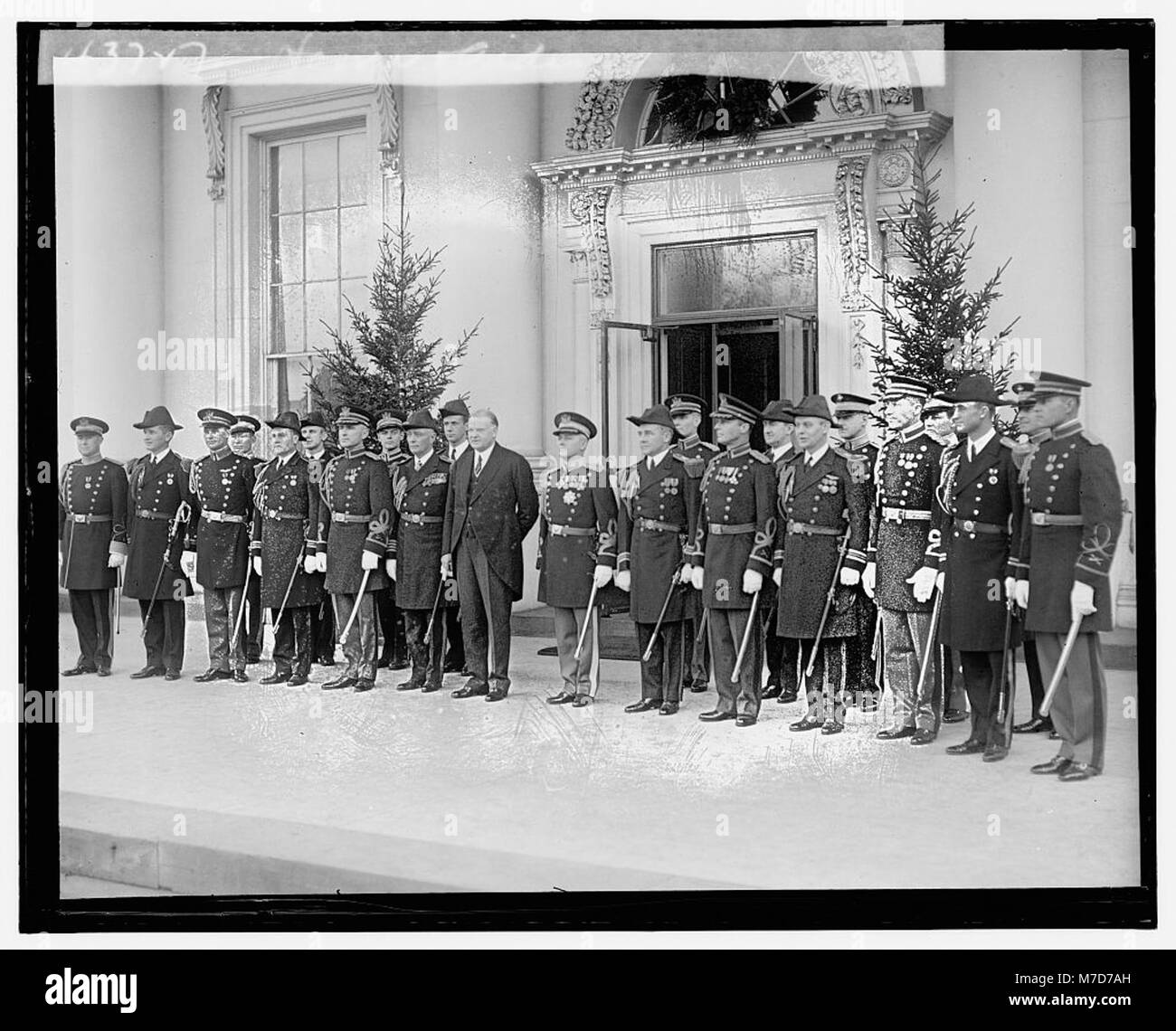 An image showing President Herbert Hoover with his aides. The ...