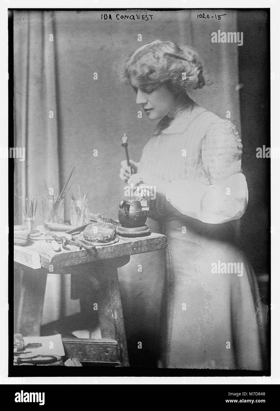 Ida Conquest captured at a working table, illustrating her role and ...