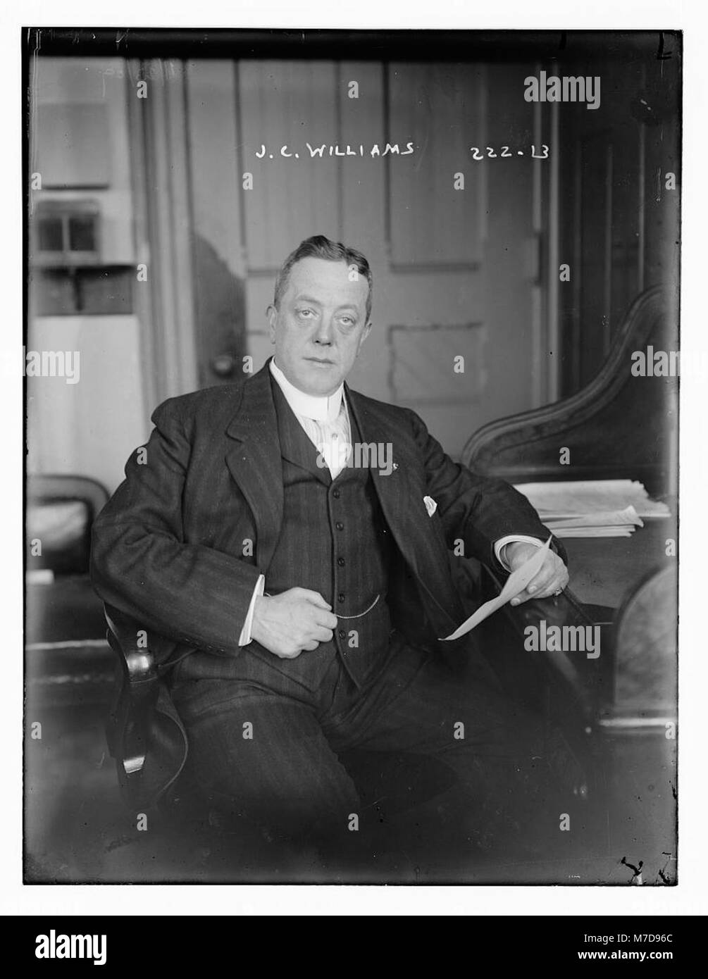 A portrait of J.C. Williams, captured in a formal photograph. The image ...