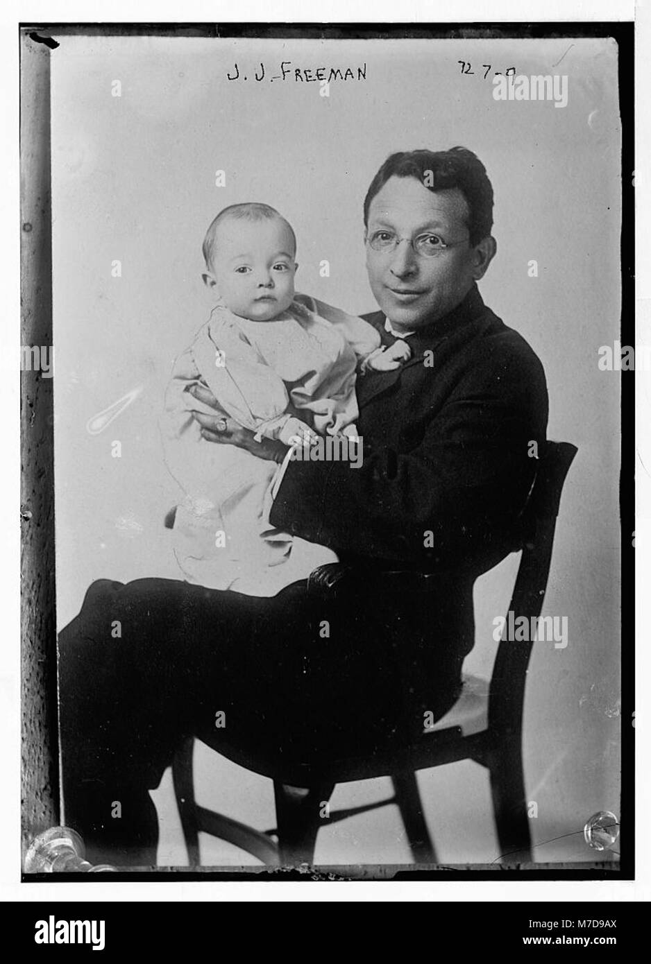 J.J. Freeman, seated, holding child LCCN2014683492 Stock Photo - Alamy