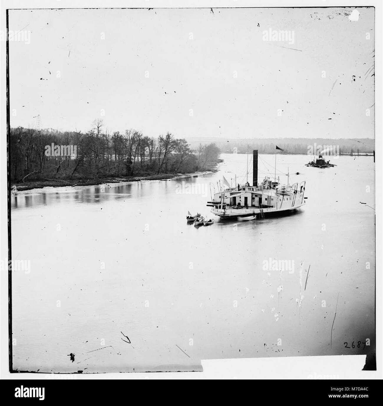 A historical photograph showing the gunboat *Commodore Perry* and a ...