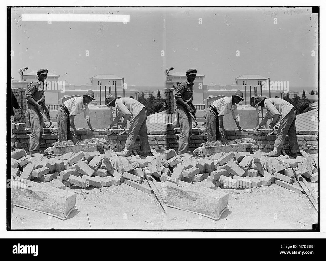 A photograph depicting the construction of a brick building in a Jewish ...