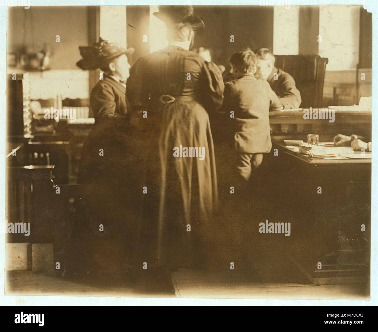 This photograph shows a young boy, a habitual truant, in Juvenile Court ...