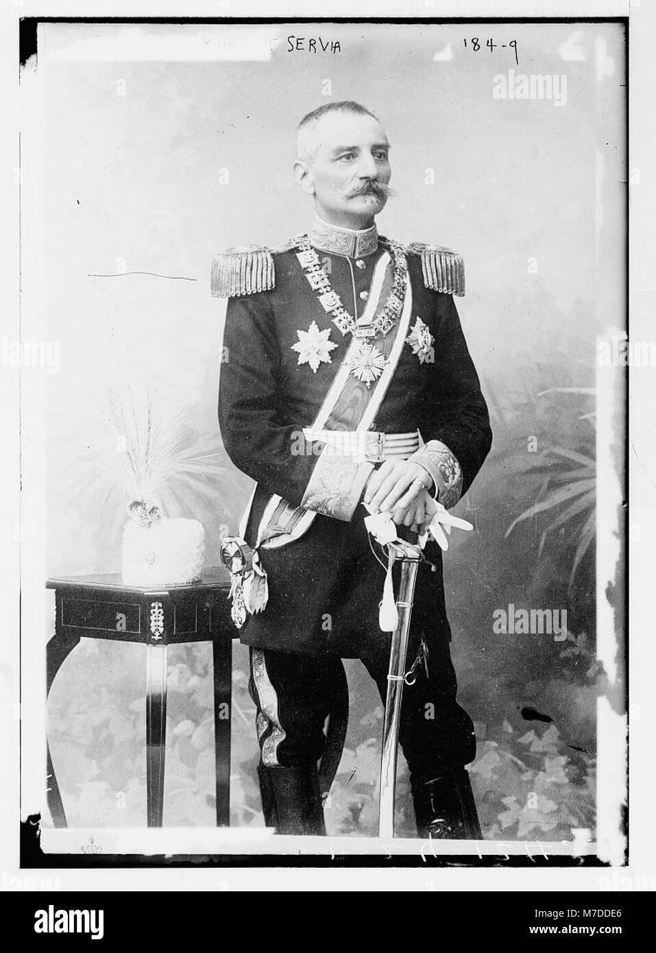 The King of Serbia is depicted in a formal military uniform ...