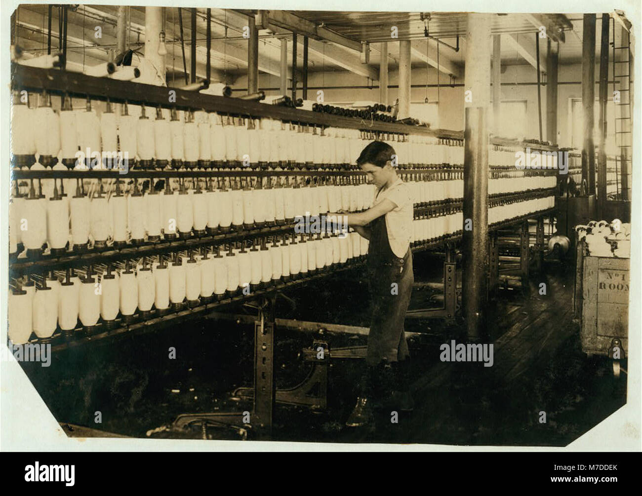 A photograph of a young boy, Charles Cavanagh, aged 15, working in the ...