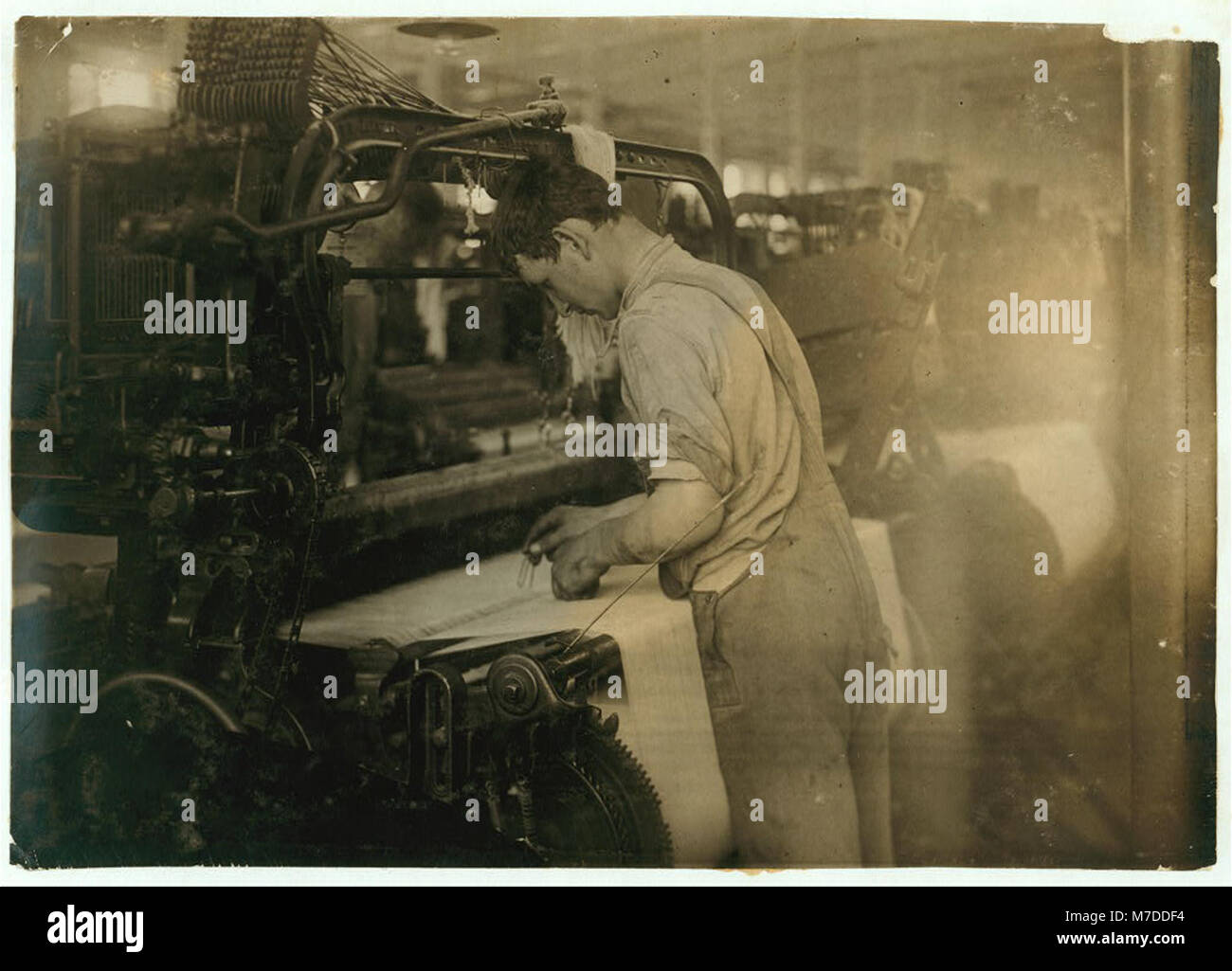 A historical image of a drop wire boy working in the King Philip Weave ...