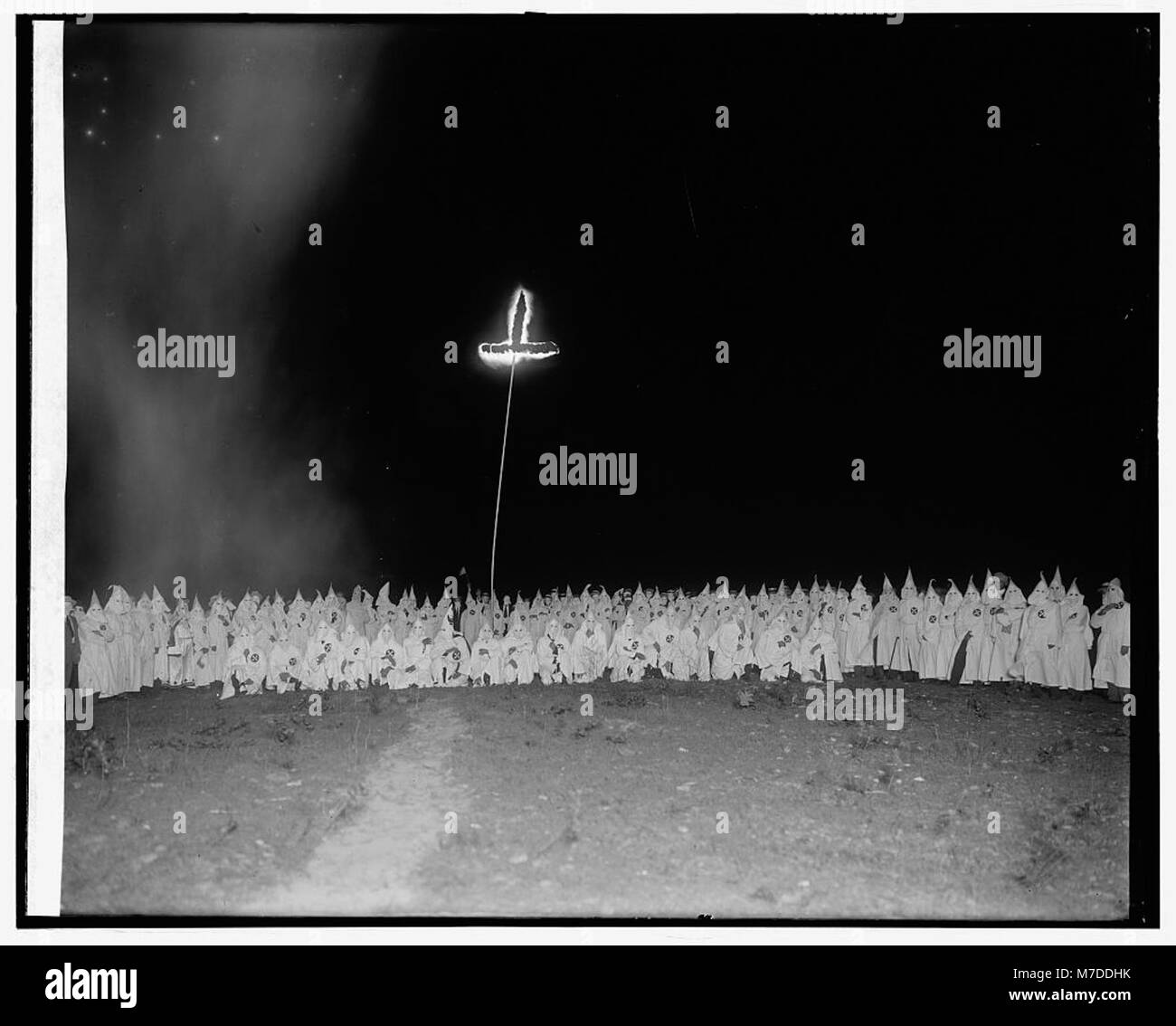 This image depicts members of the Ku Klux Klan, capturing their historical role in the context ...