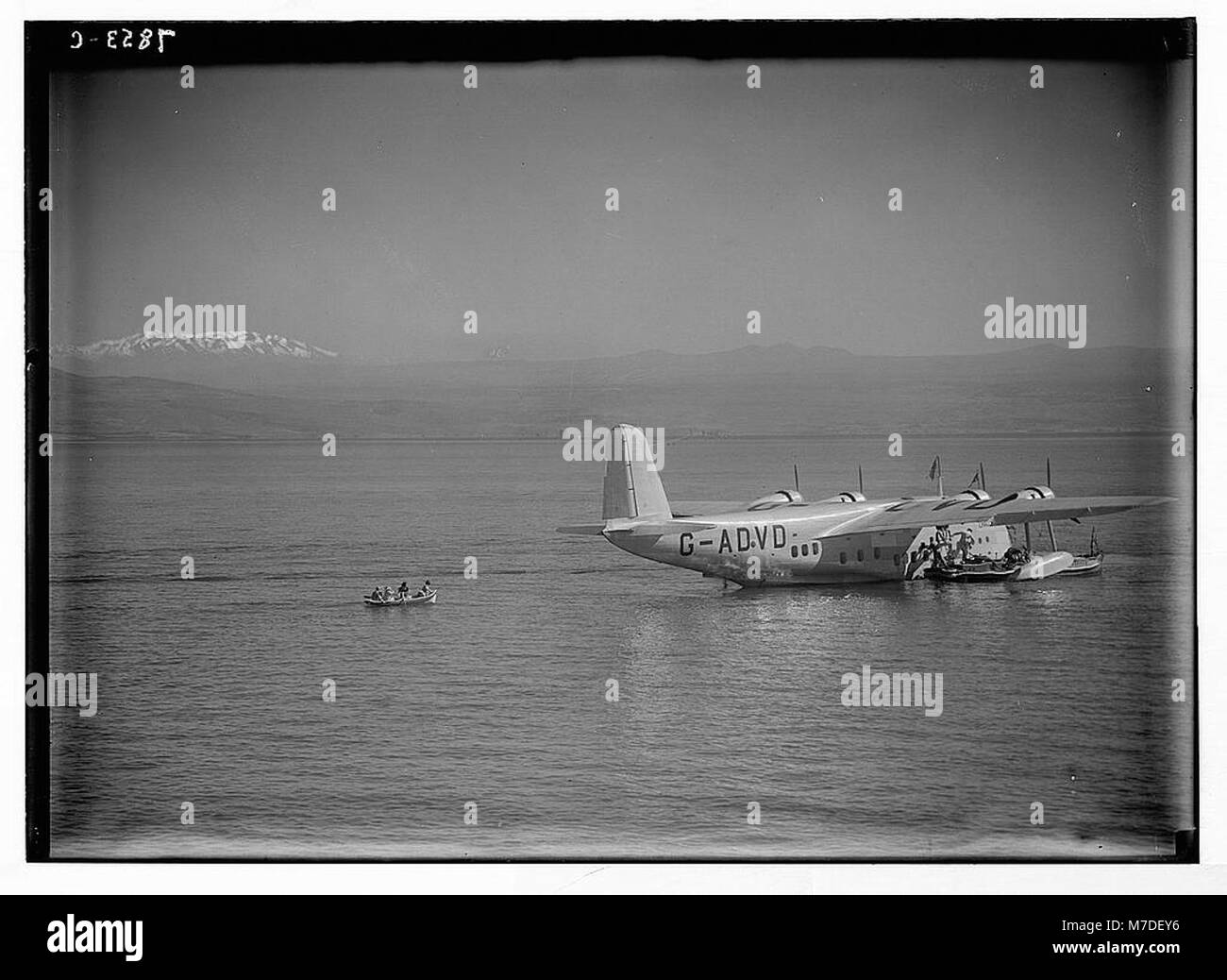 A photograph showing the flying boat 'Clio' in flight over a lake with ...